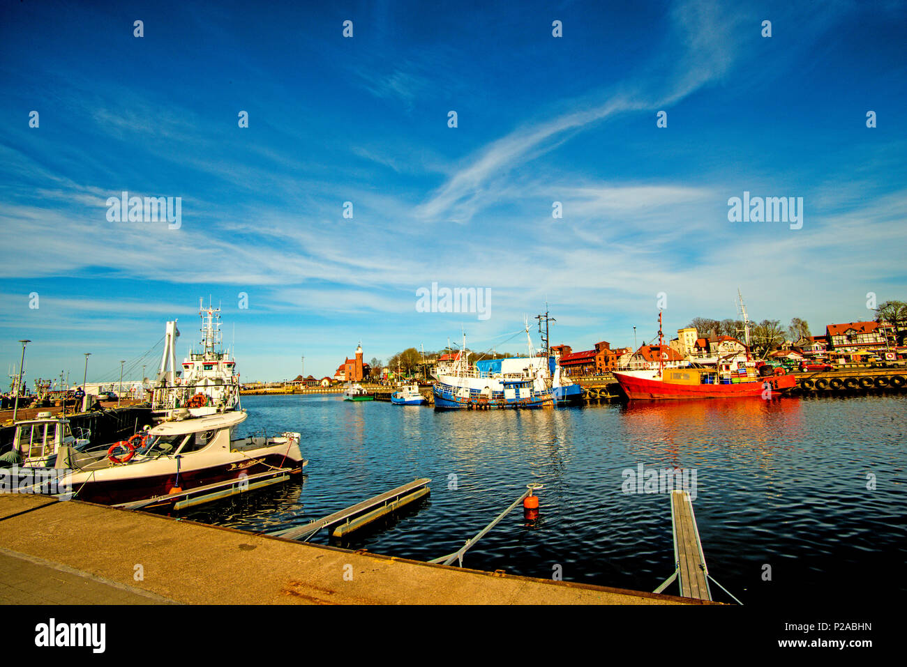 Fishing port of Ustka with old lighthouse Stock Photo - Alamy