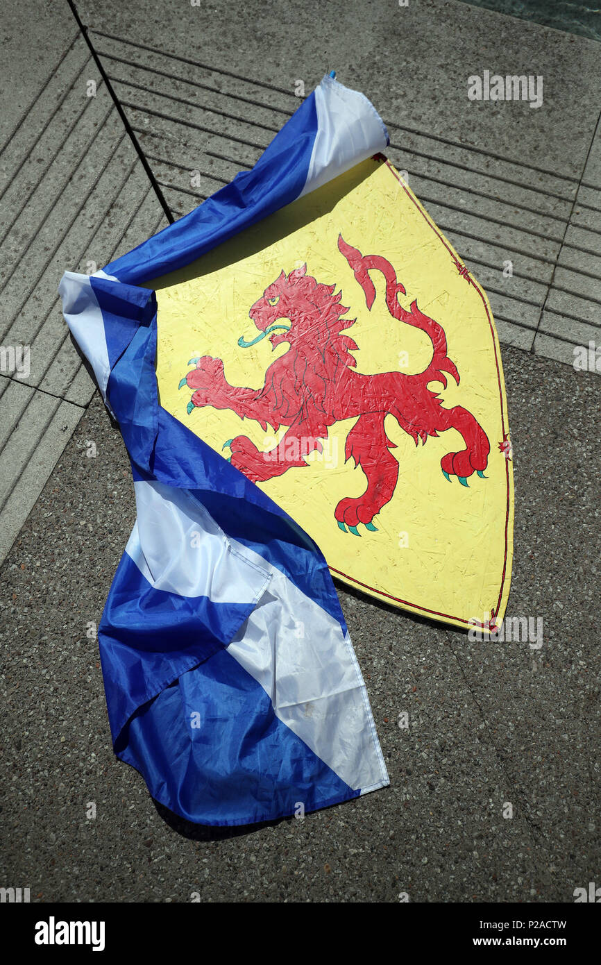 A Saltire flag and Scottish Lion Rampant shield lie on the ground as ...