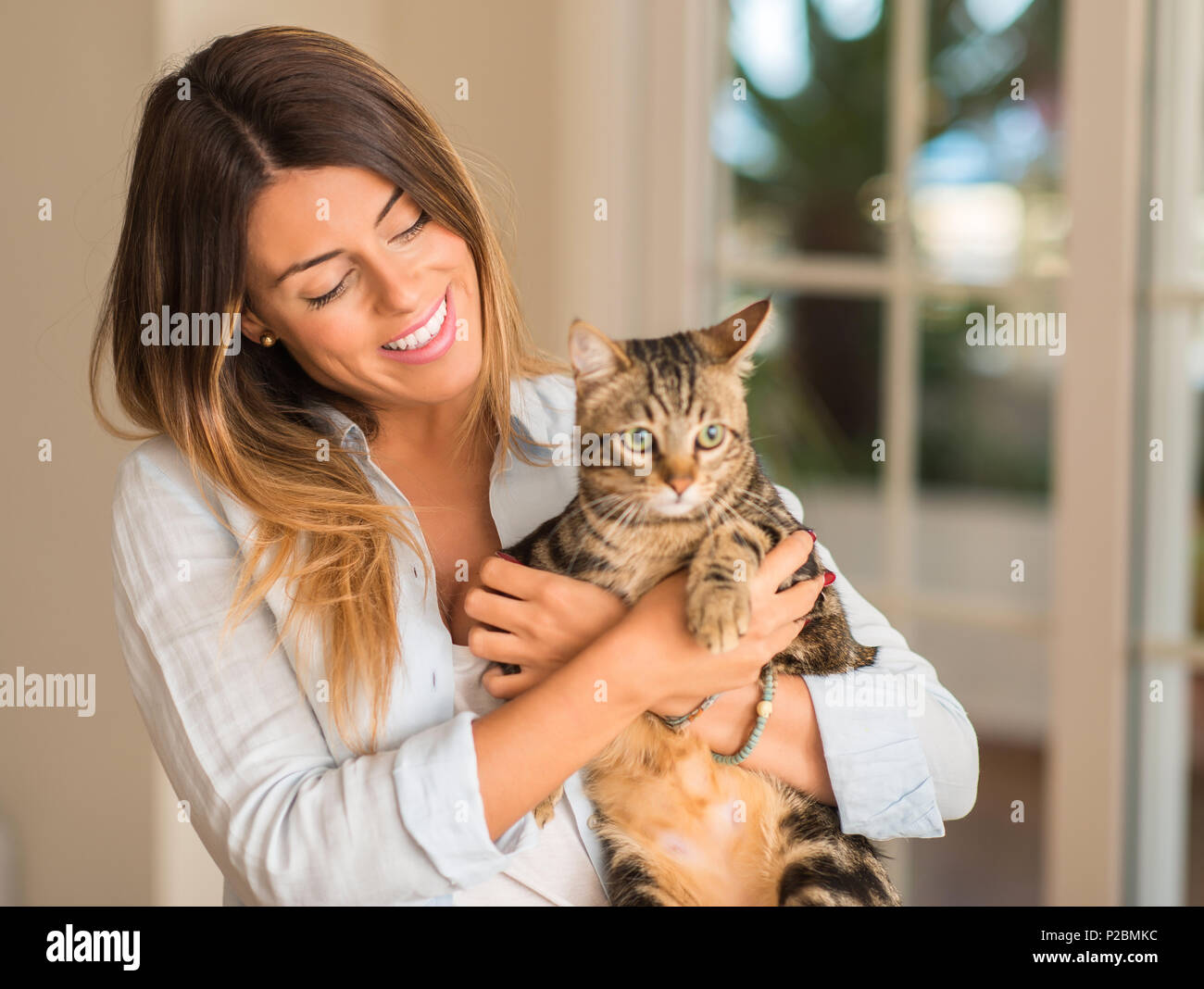 Pet cat love adult cuddle hi-res stock photography and images - Alamy