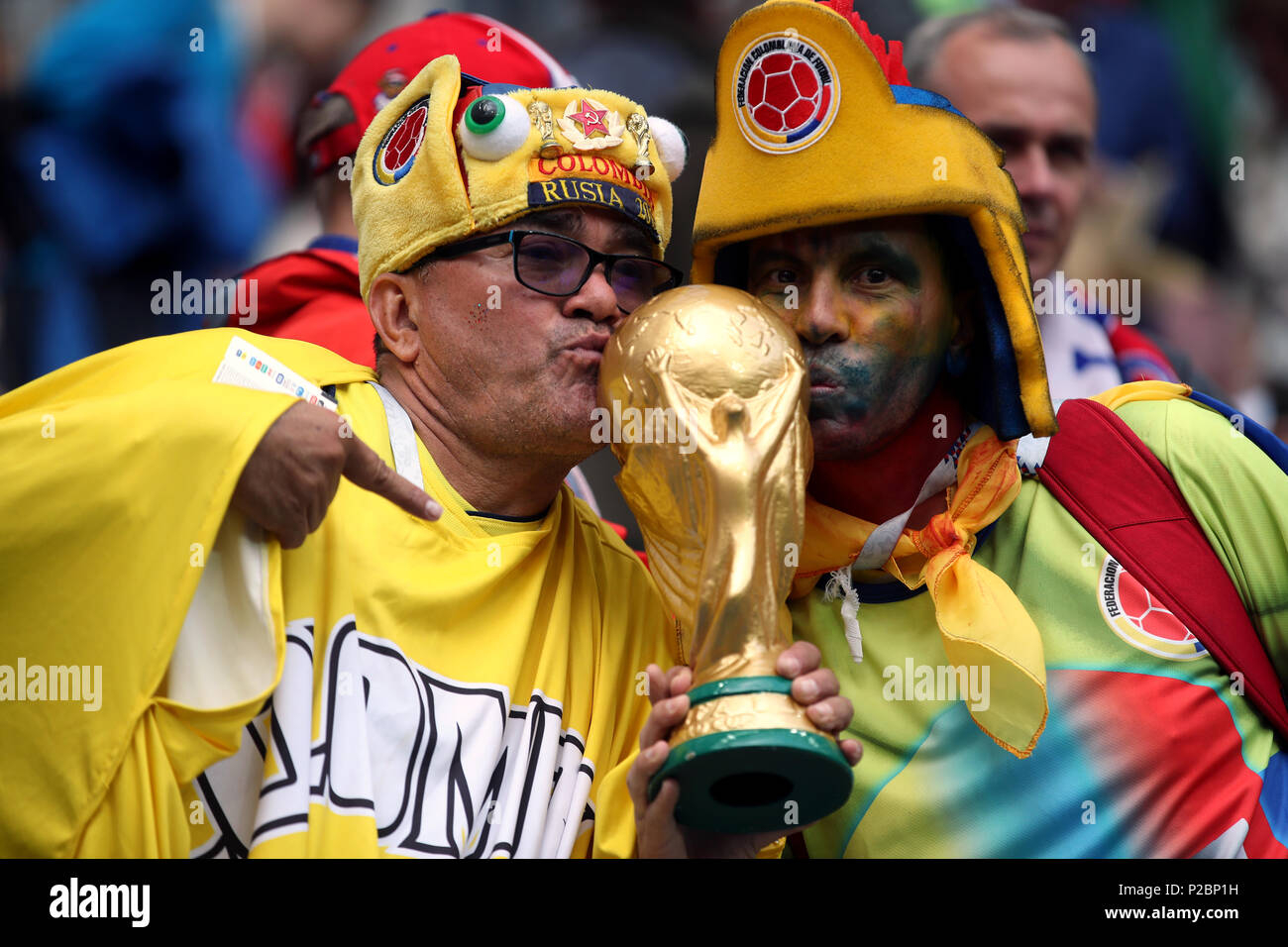 Colombia fans kiss a replica world cup trophy during the FIFA World Cup ...