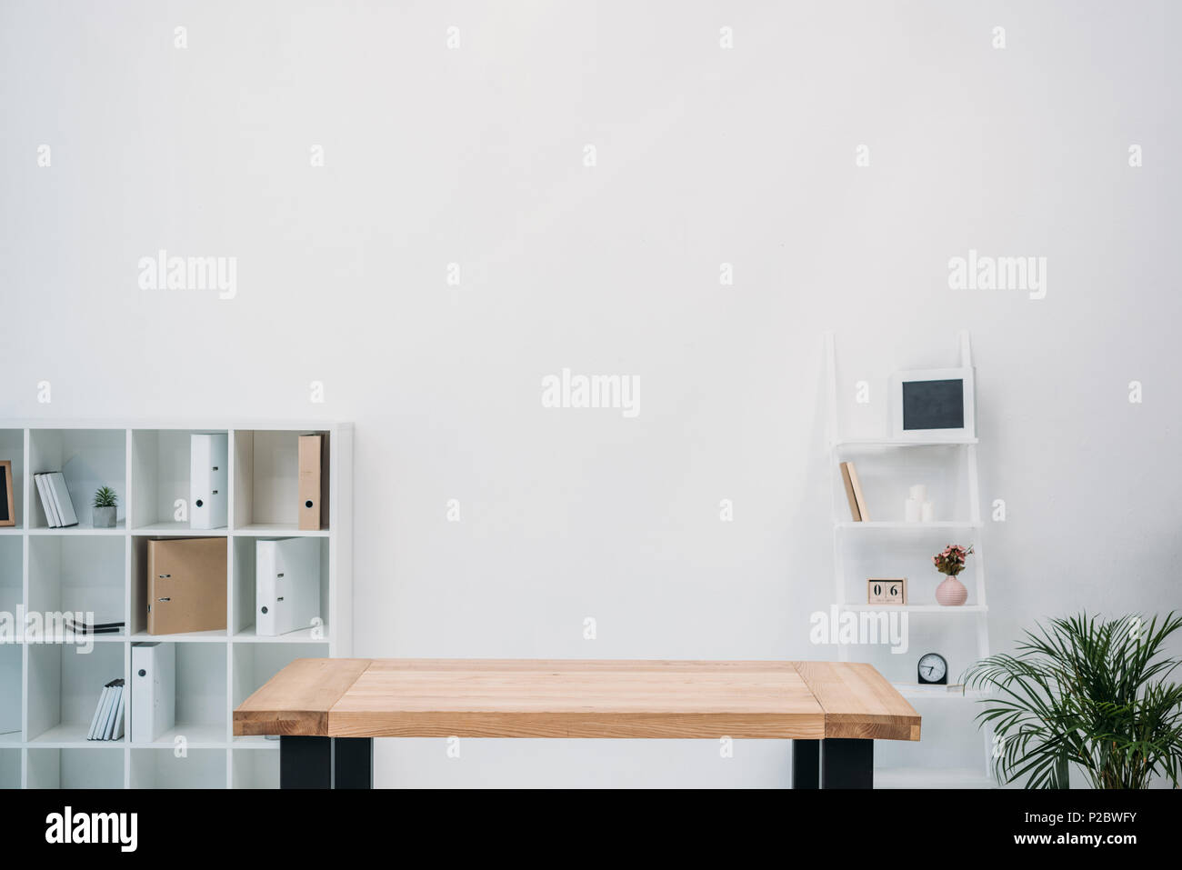 modern office interior with empty wooden table and folders on shelves ...