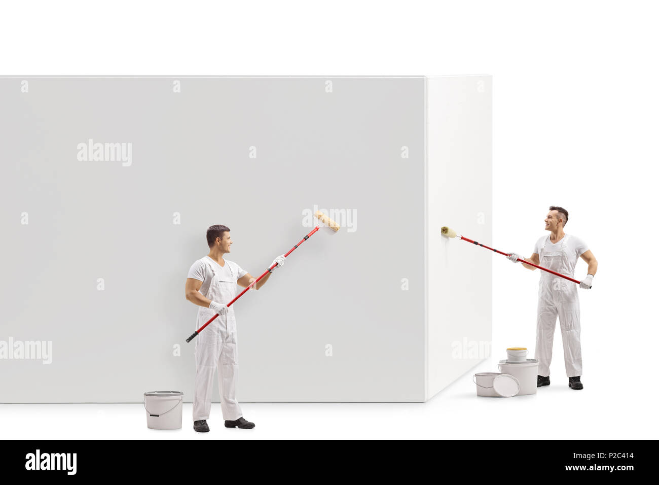 Full length profile shot of two painters painting a wall isolated on ...