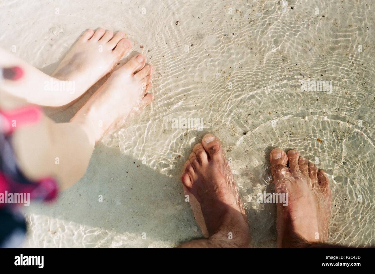 Foot Couple In Ocean Water Stock Photo - Alamy