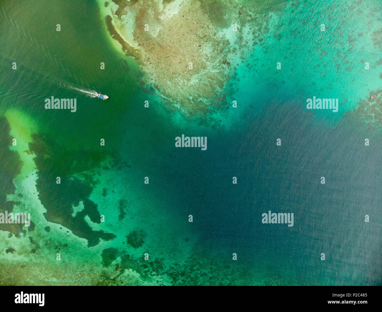 Aerial view of boat over coral reef Stock Photo - Alamy