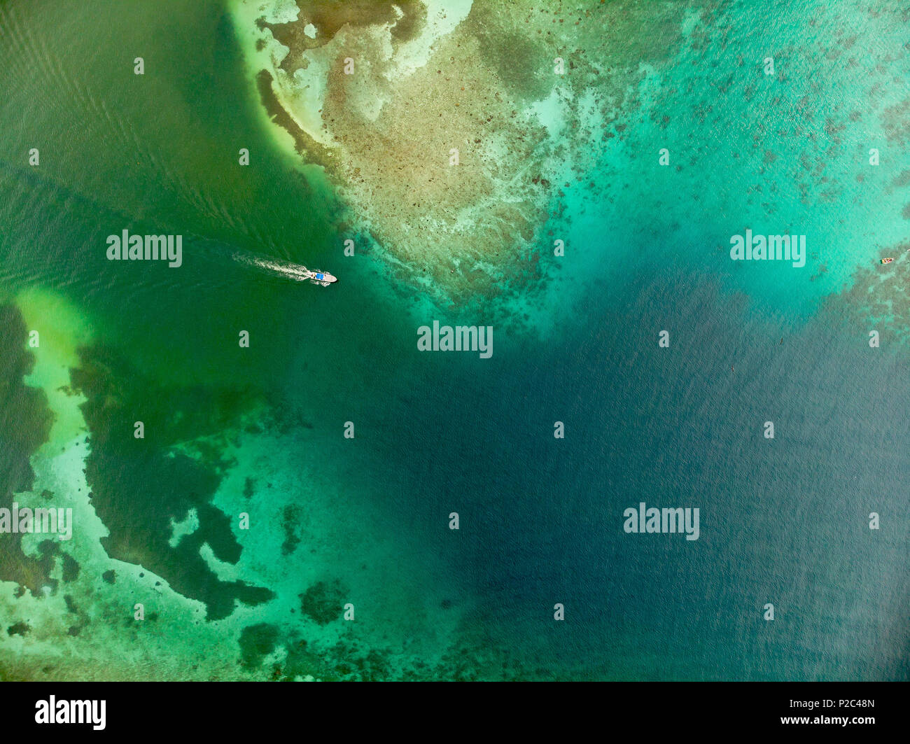 Aerial view of boat over coral reef Stock Photo - Alamy