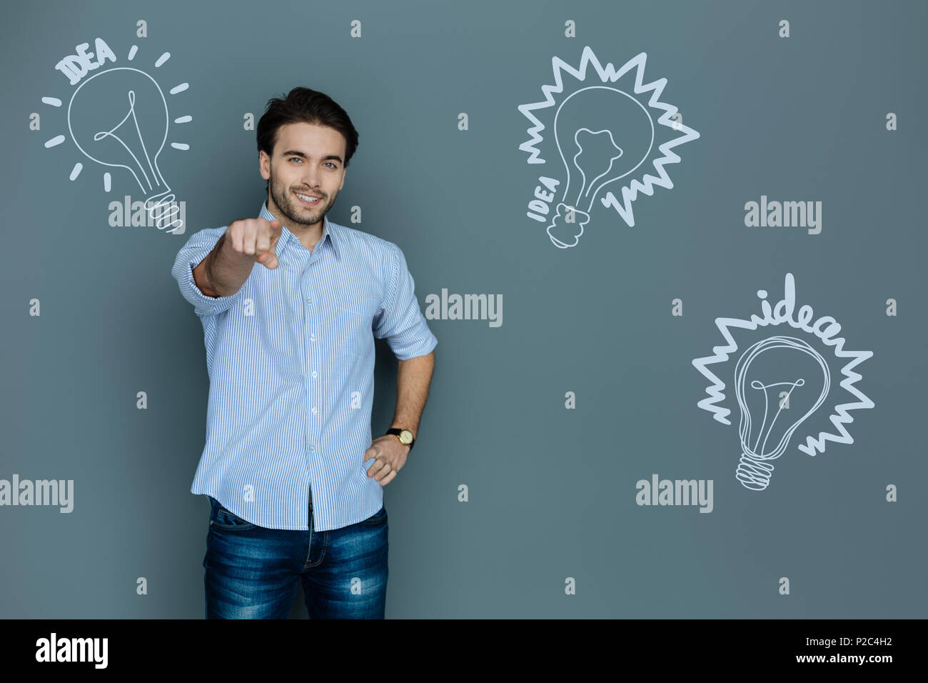 HR manager smiling and pointing at young while having an idea Stock ...