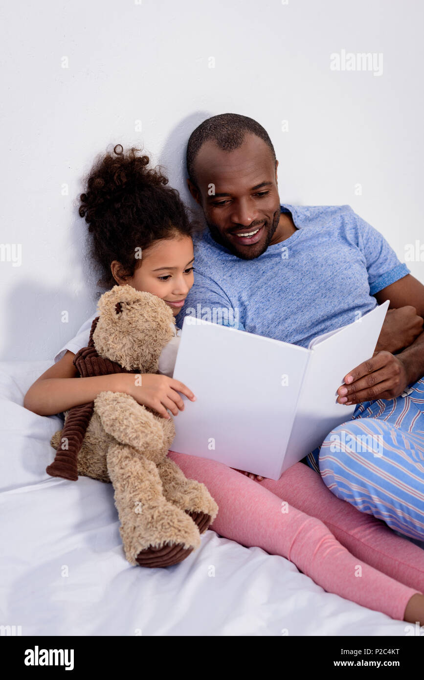 african american father reading for daughter at home Stock Photo - Alamy