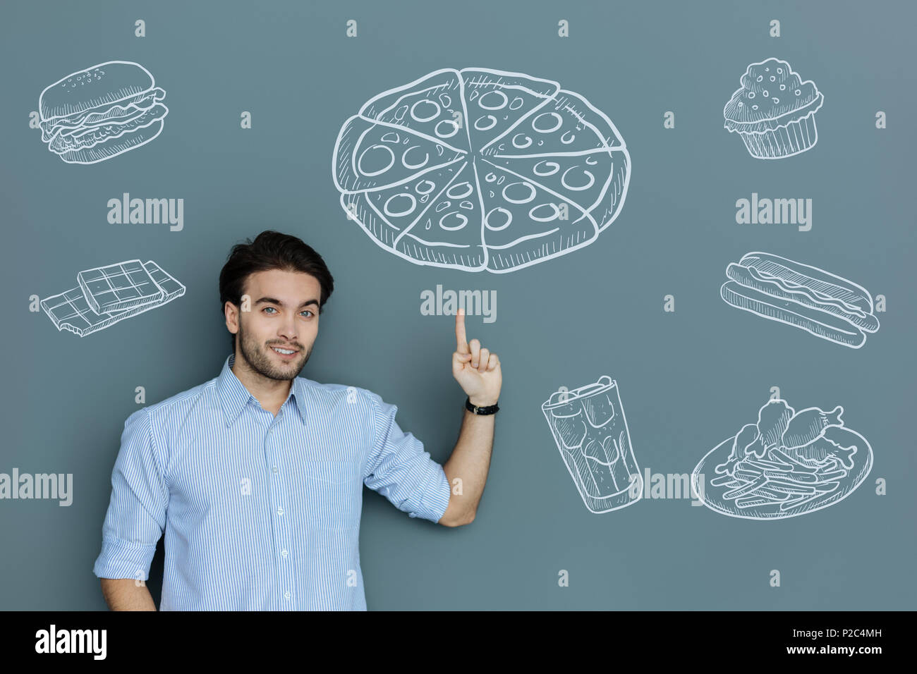 Happy customer ordering a big pizza and pointing at it Stock Photo - Alamy
