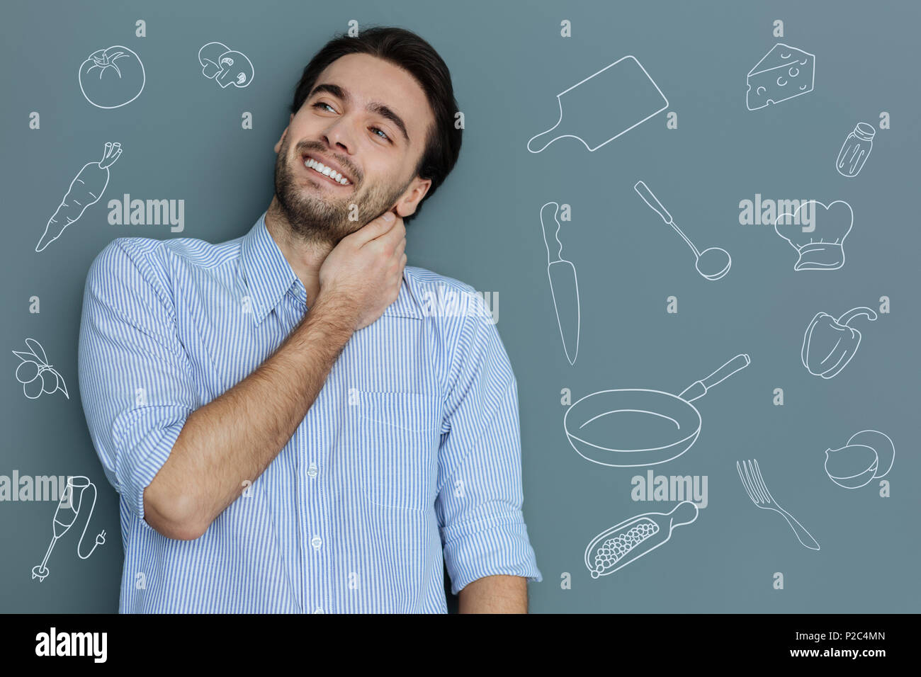Positive cook touching his neck and smiling happily Stock Photo - Alamy