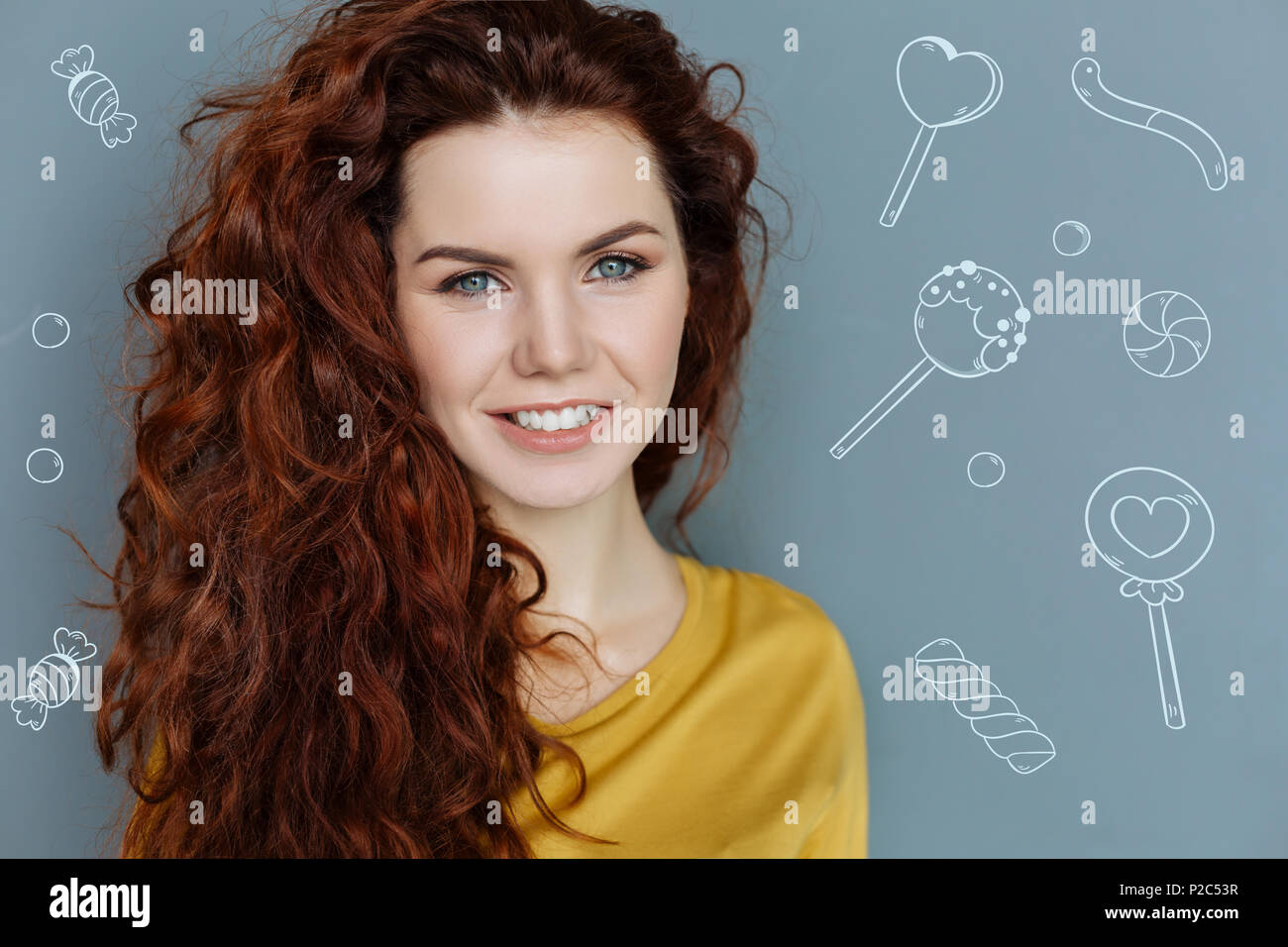 Beautiful woman smiling while choosing candies in the shop Stock Photo ...