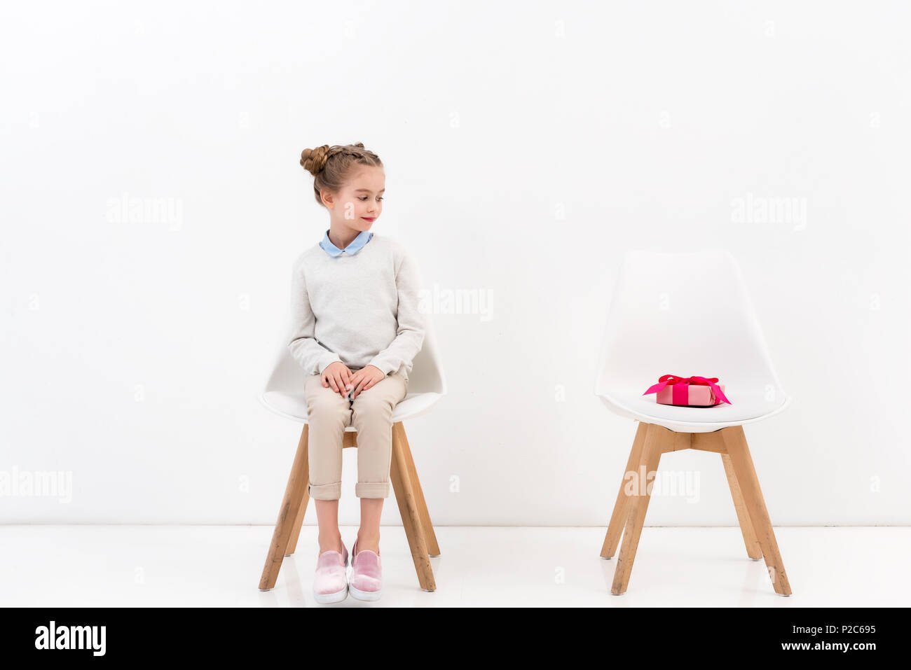 Child sitting on chair hi-res stock photography and images - Alamy