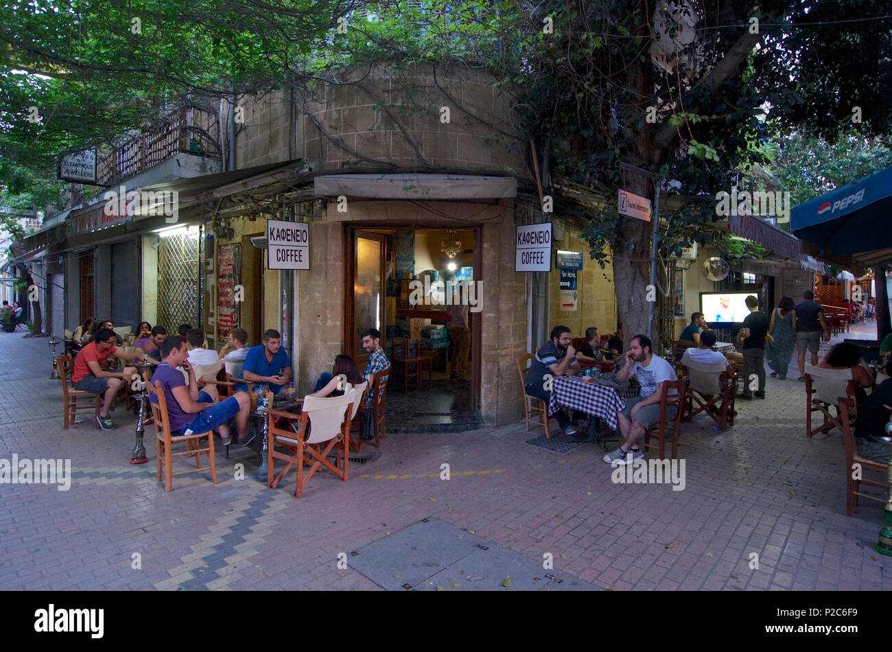 People sitting at tables in a cafe in a street in Lefkosia, Nicosia ...