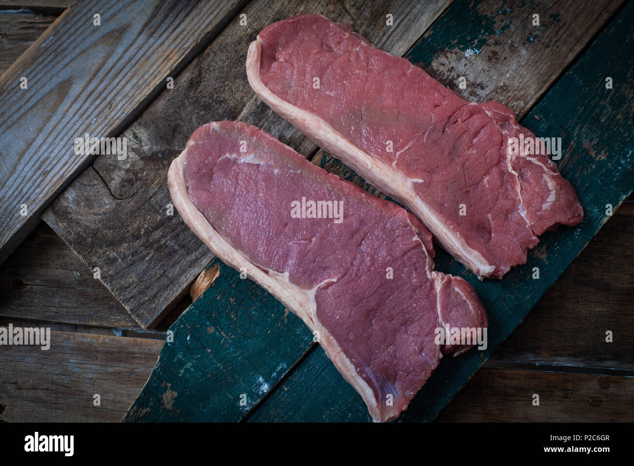 two angus beef steak on wood table Stock Photo - Alamy