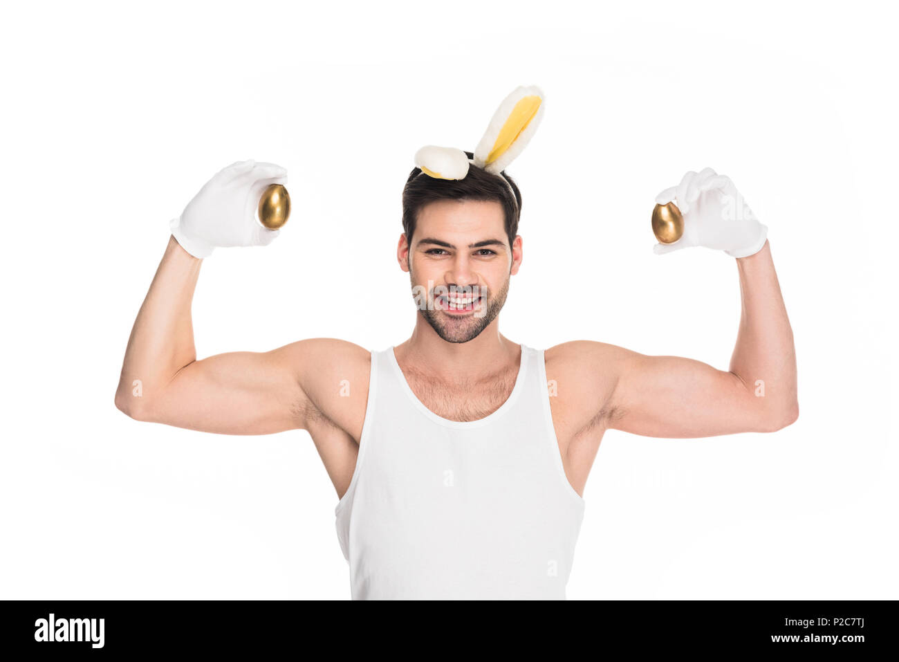 Man with bunny ears showing muscles and holding golden eggs isolated on ...