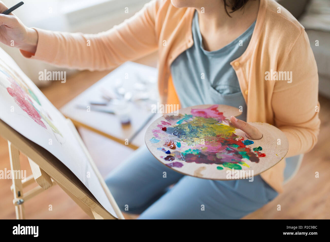 artist with palette painting at art studio Stock Photo - Alamy