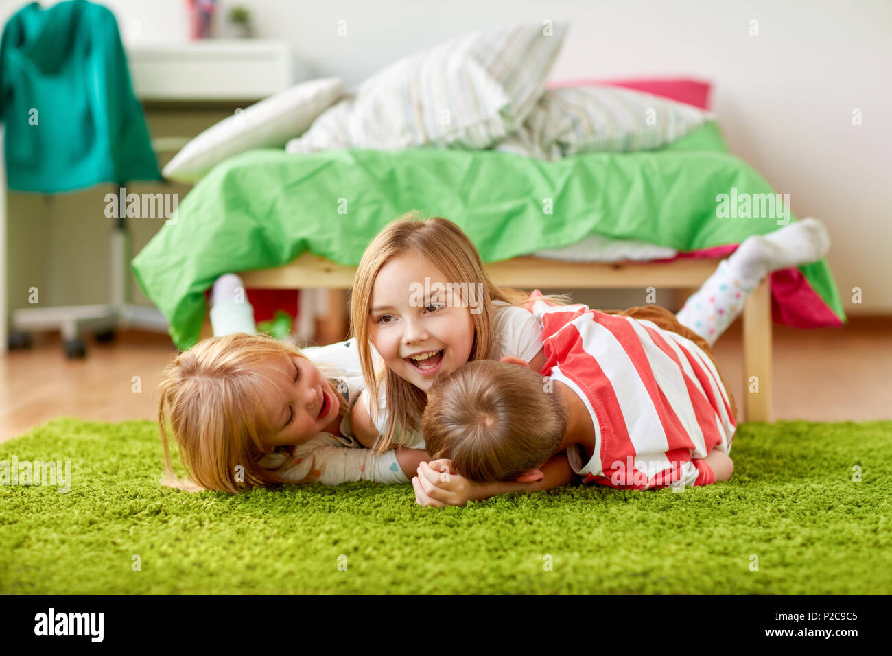 happy little kids lying on floor or carpet Stock Photo - Alamy