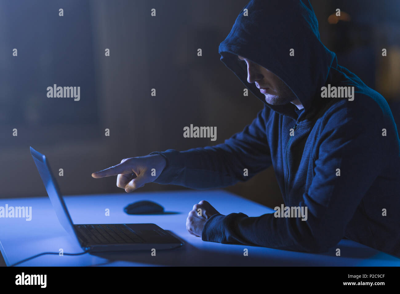 hacker pointing at laptop computer in dark room Stock Photo - Alamy