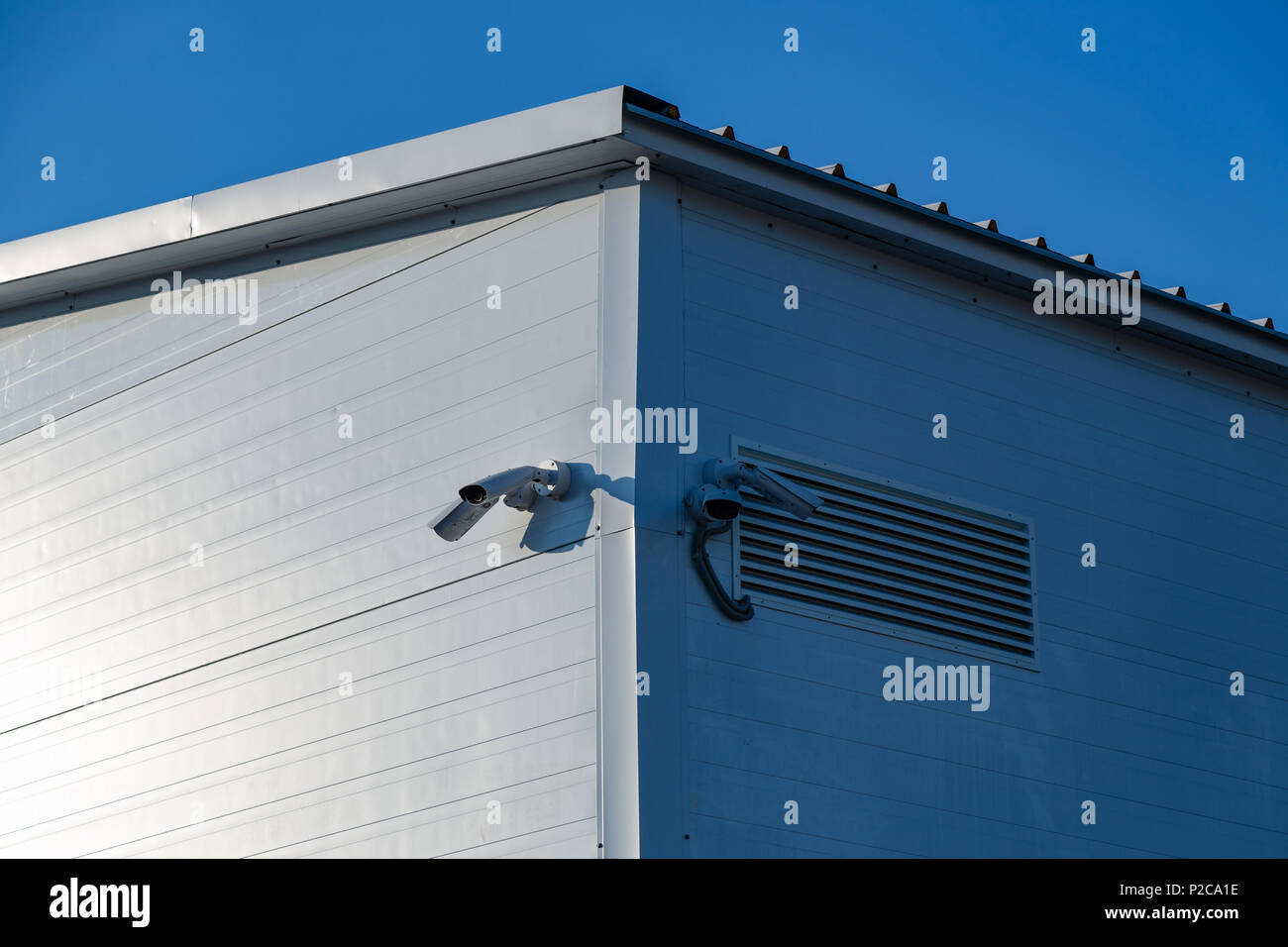 Cameras of video surveillance at the corner of the building against the ...