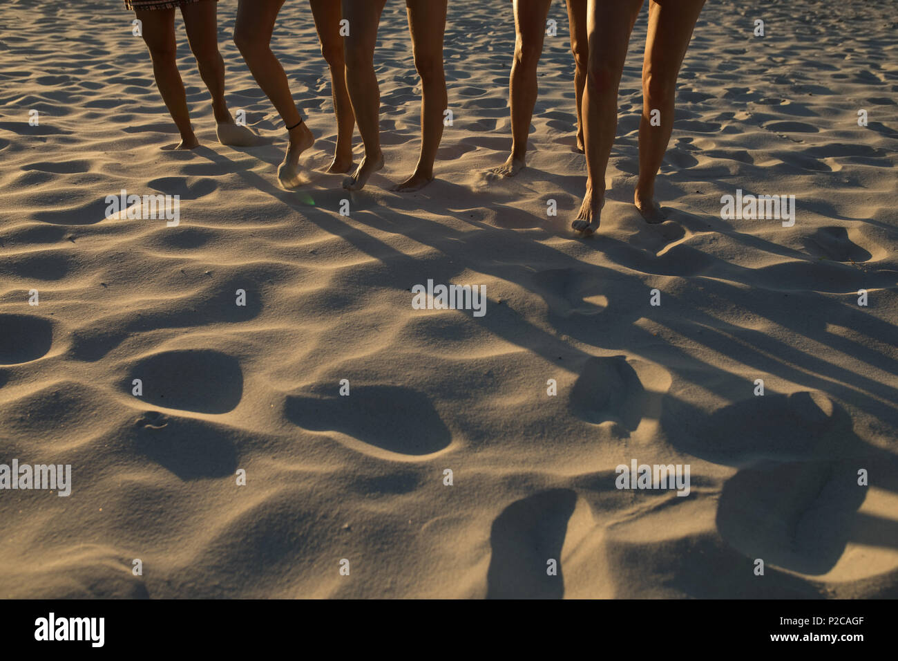 Female volleyball players running on the beach Stock Photo - Alamy