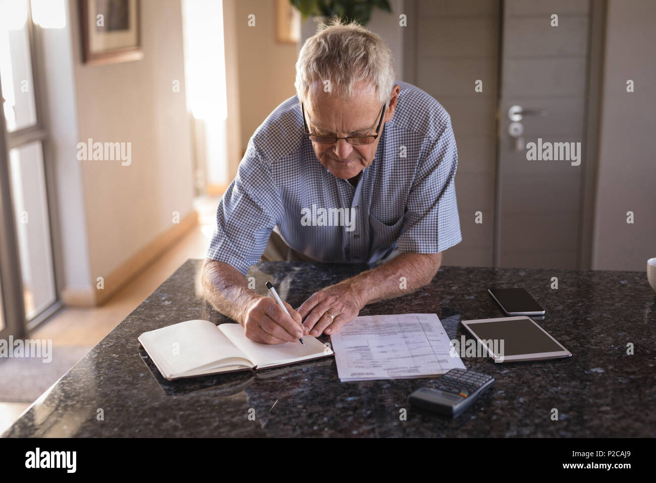 Senior man writing hi-res stock photography and images - Alamy