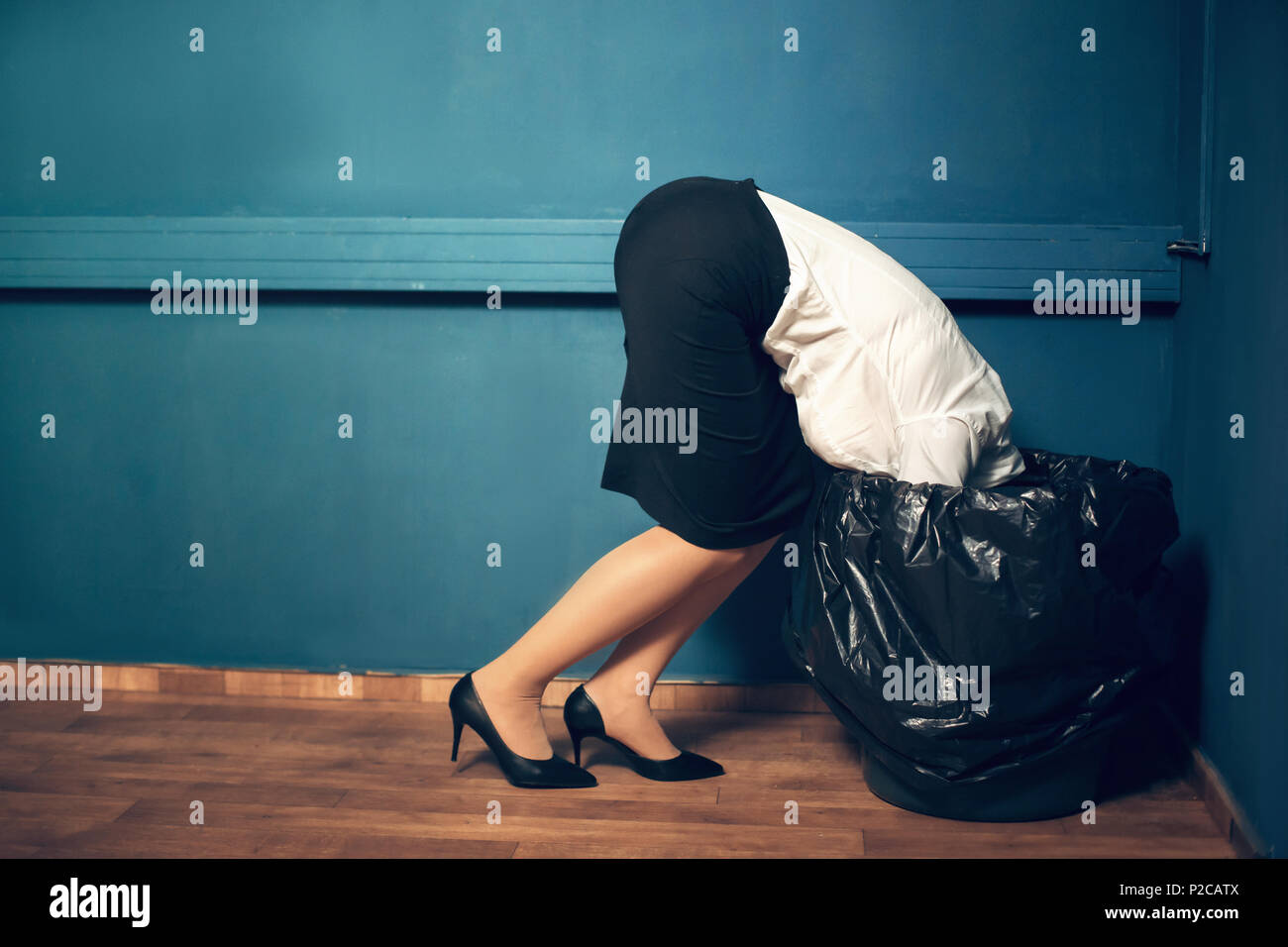 Woman with her head in garbage bin Stock Photo - Alamy