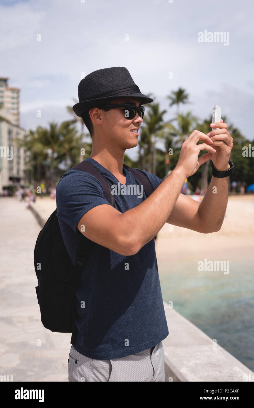 Man clicking photo with mobile phone Stock Photo - Alamy