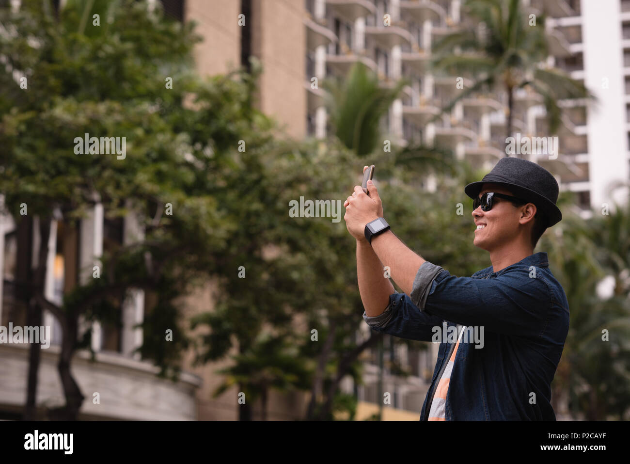Man clicking photo with mobile phone Stock Photo - Alamy