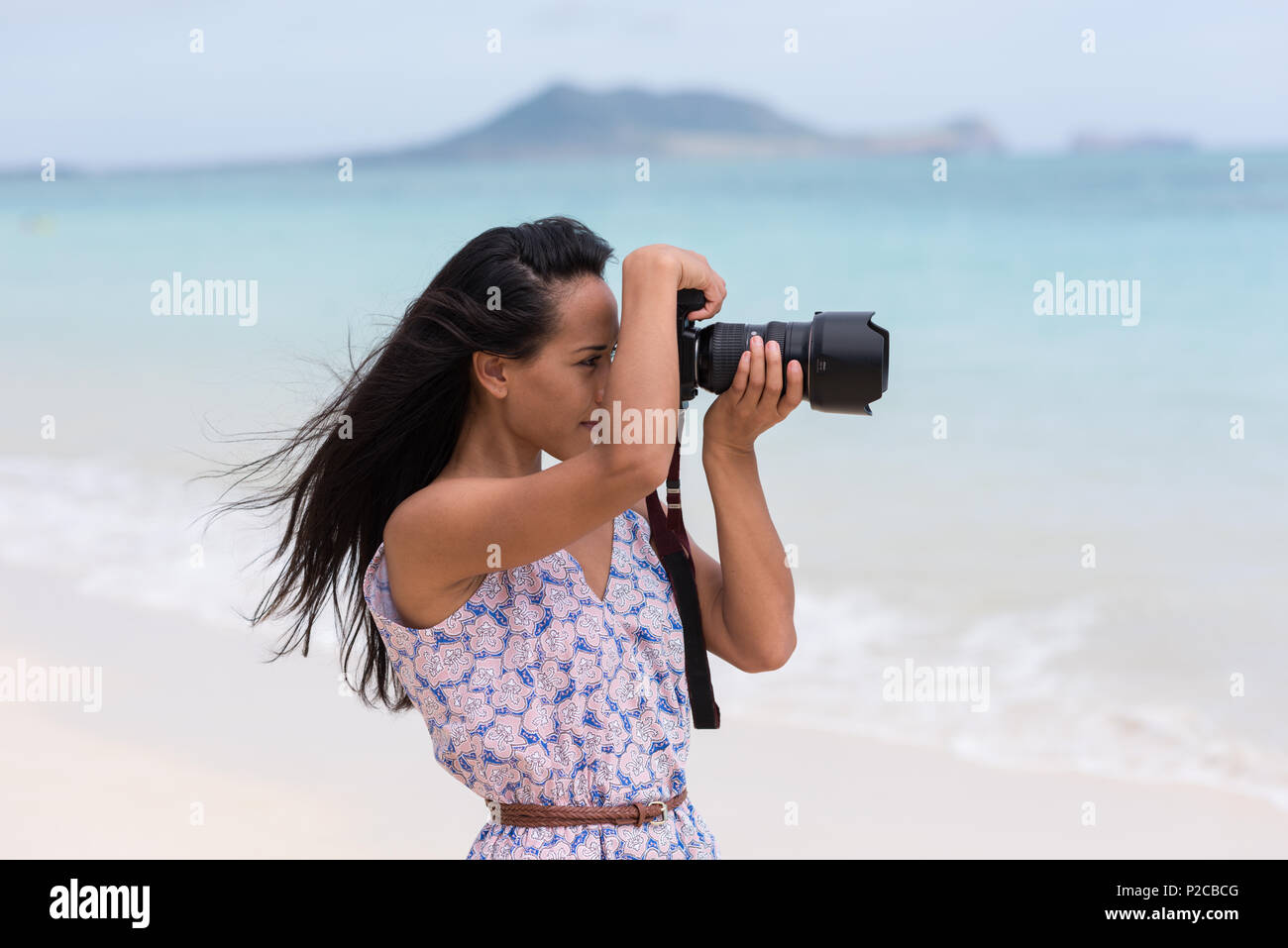 Woman clicking photo with digital camera in the beach Stock Photo - Alamy