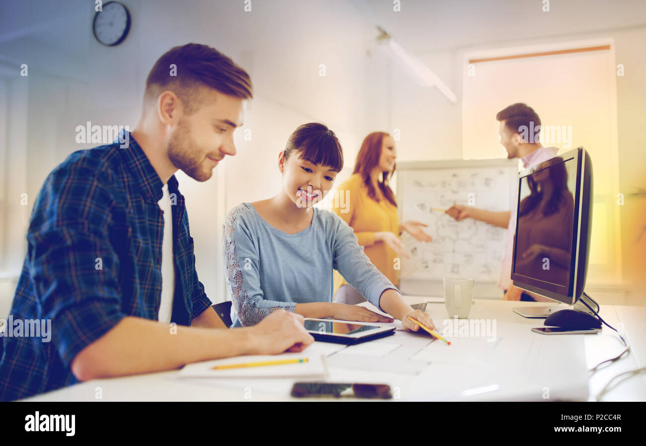 creative team with blueprint at office Stock Photo - Alamy