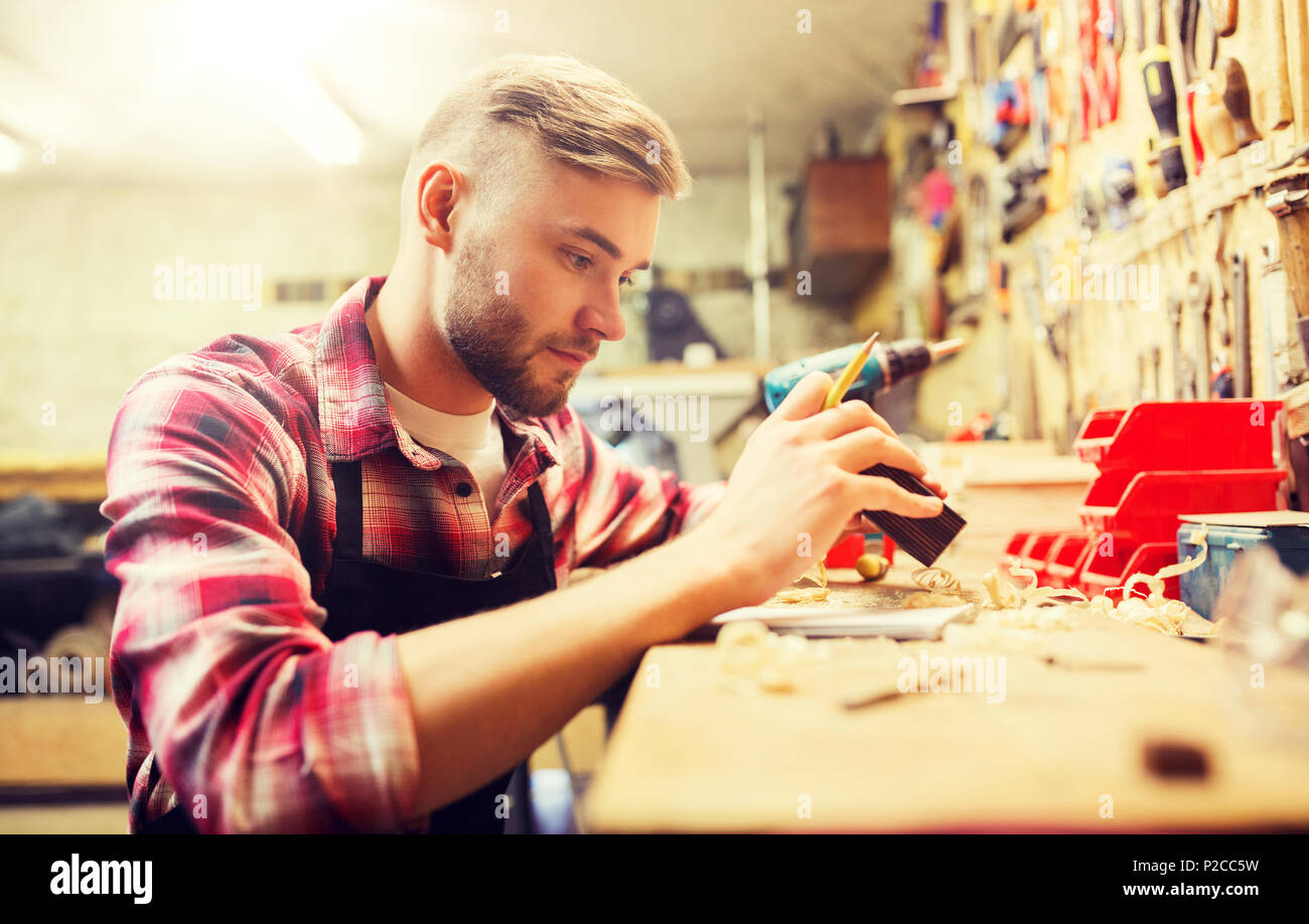 carpenter working with wood plank at workshop Stock Photo - Alamy