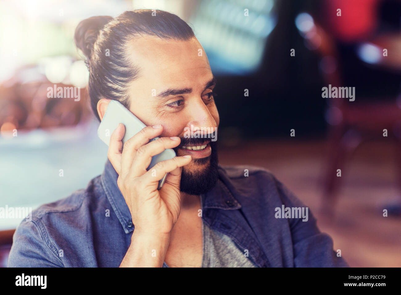 happy man calling on smartphone at bar or pub Stock Photo - Alamy