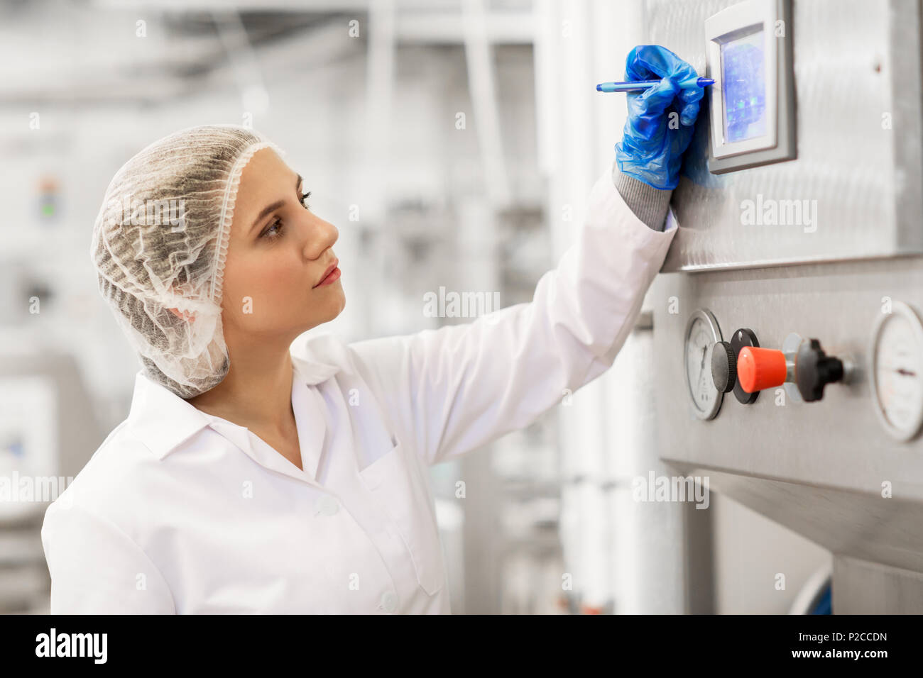 woman programming computer at ice cream factory Stock Photo - Alamy