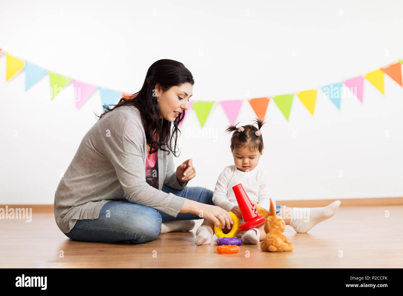 mother and baby daughter playing with pyramid toy Stock Photo - Alamy