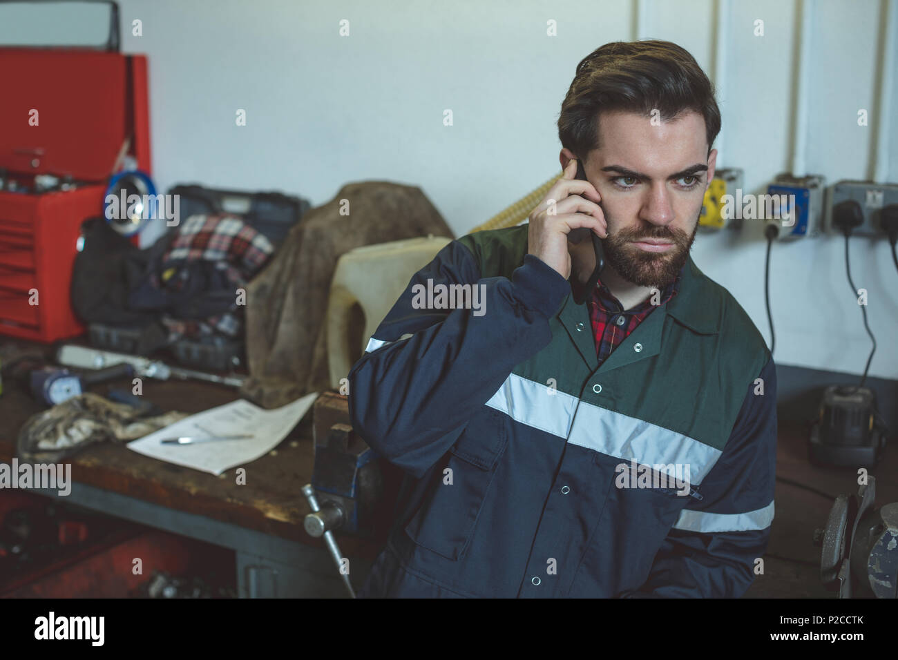 Mechanic talking on mobile phone Stock Photo - Alamy