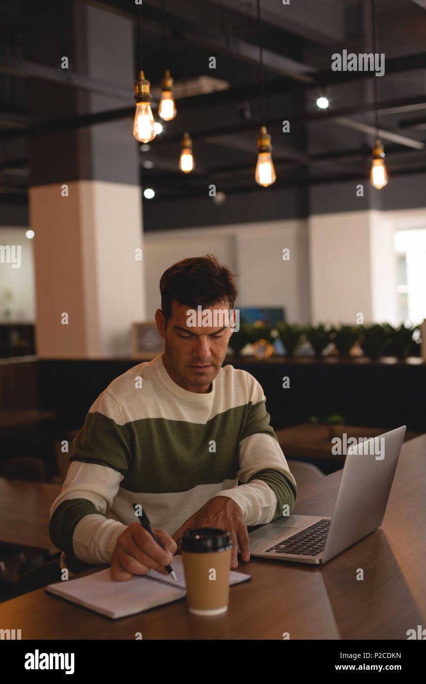 Mature businessman writing in notebook hi-res stock photography and ...