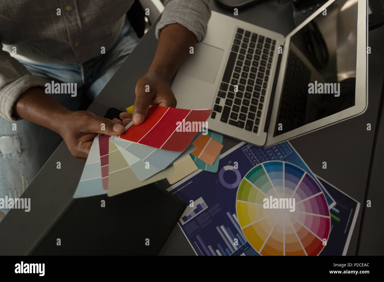 Male graphic designer looking at color swatch Stock Photo - Alamy