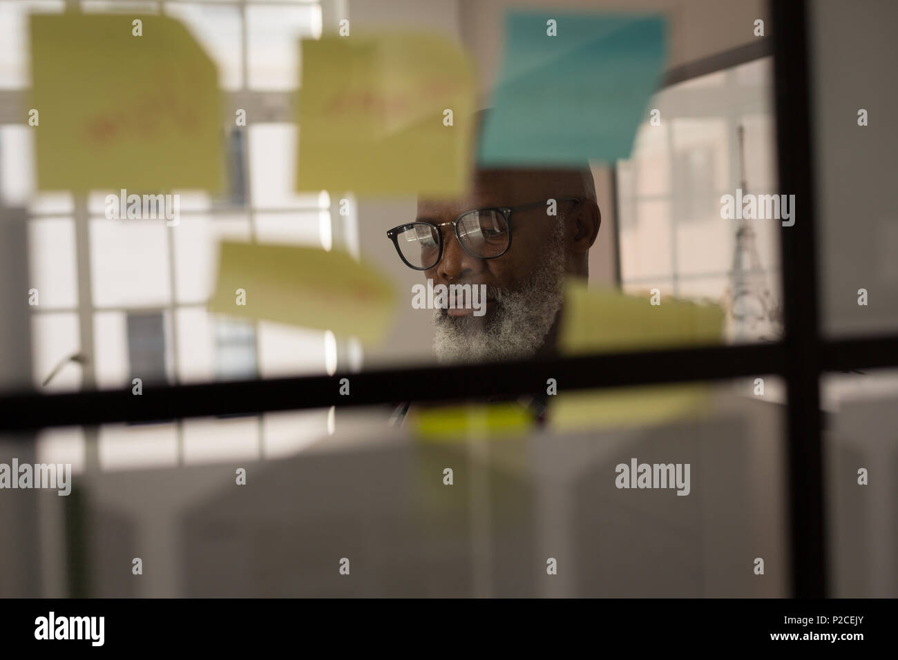 Senior graphic designer working in office Stock Photo - Alamy