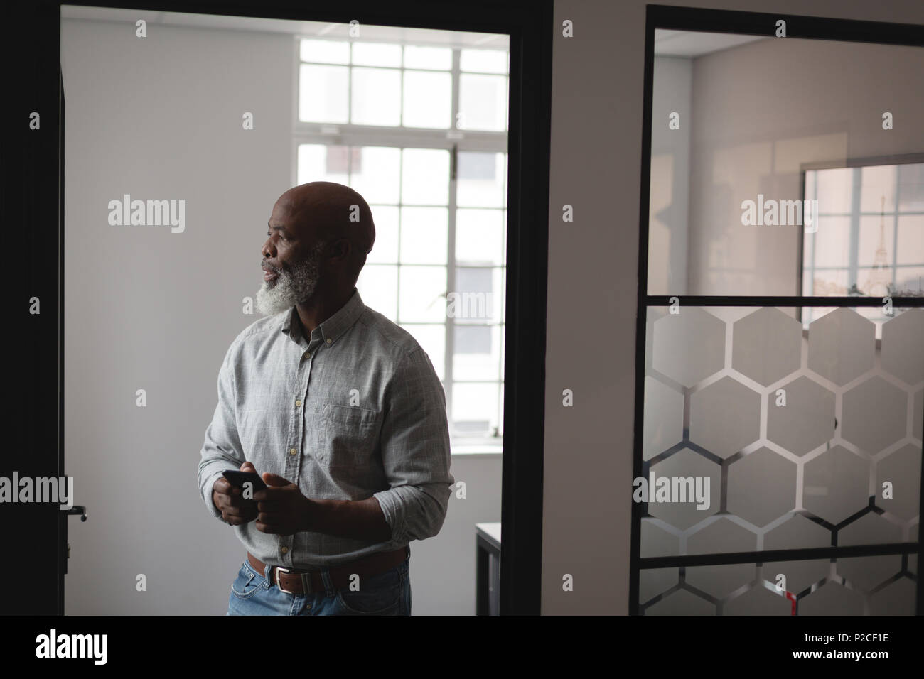 Senior graphic designer using mobile phone Stock Photo - Alamy