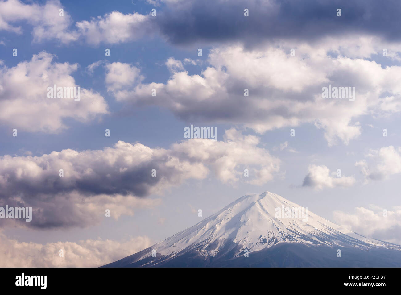 The peak of Mount Fuji covered in snow with a beautiful sky before ...