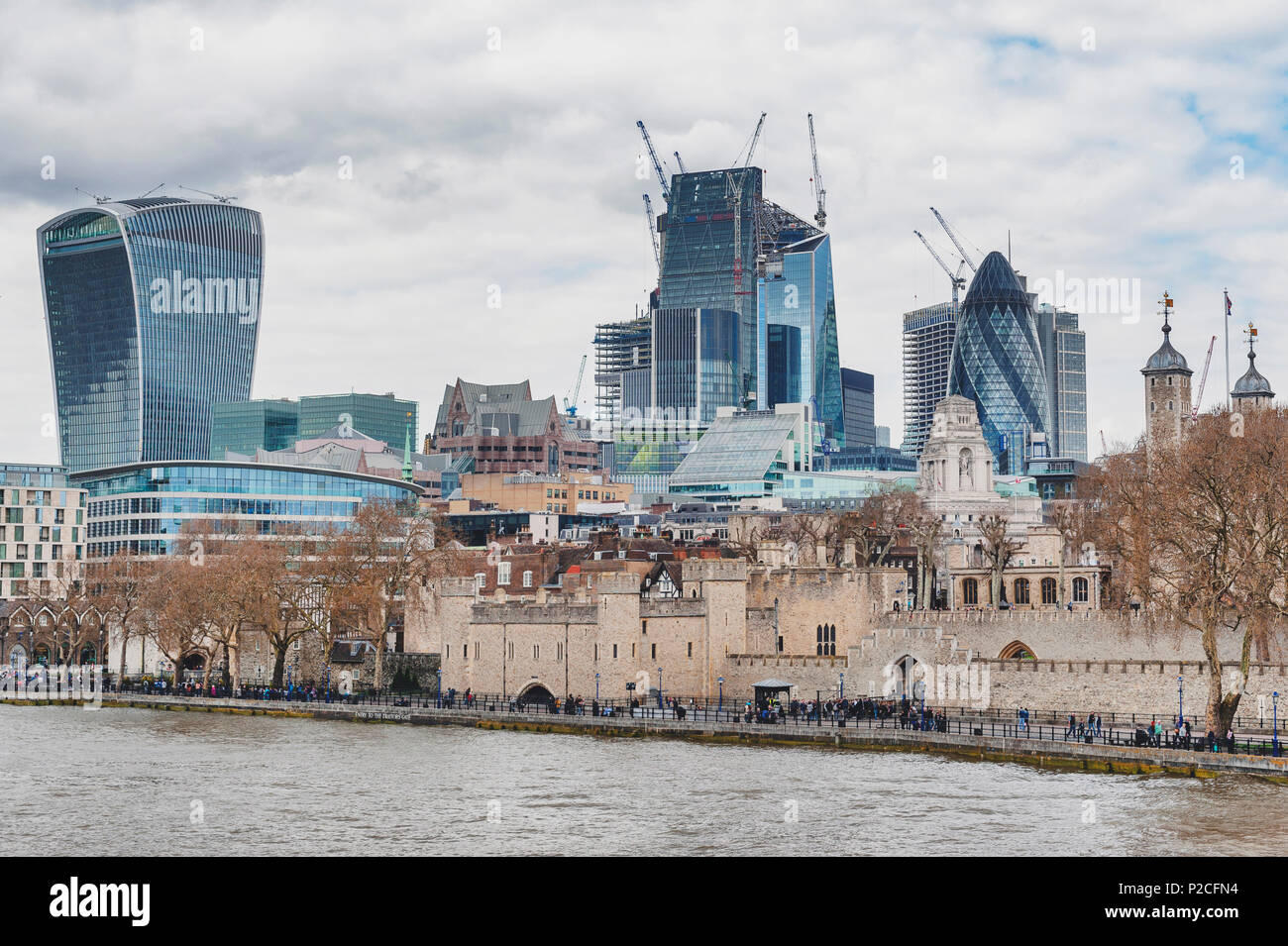 Tower of London located by the River Thames with skyscrapers and ...