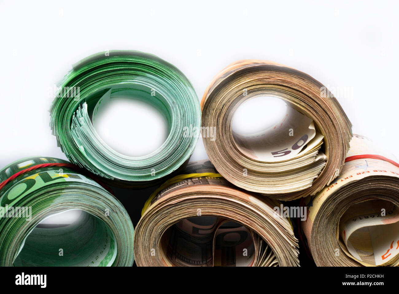 Rolled several thousand euro banknotes with rubbers background. Euro ...