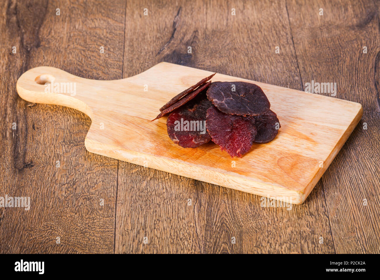 Dry beef meat over wooden Stock Photo - Alamy