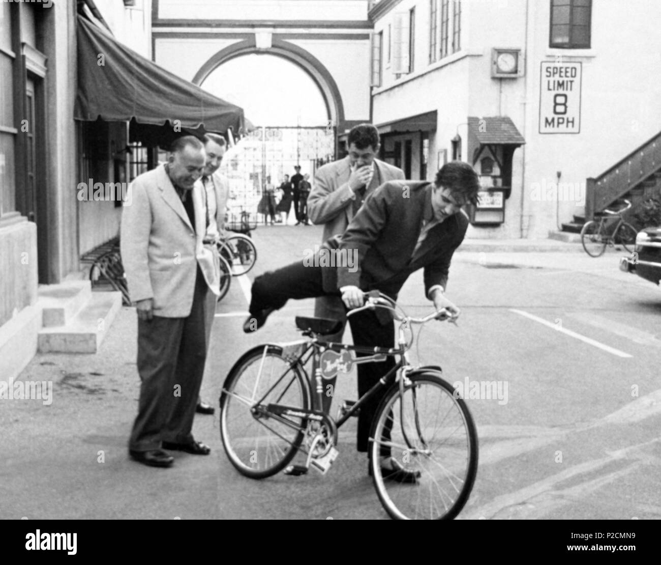 The American singer Elvis Presley trying a bicycle Stock Photo - Alamy