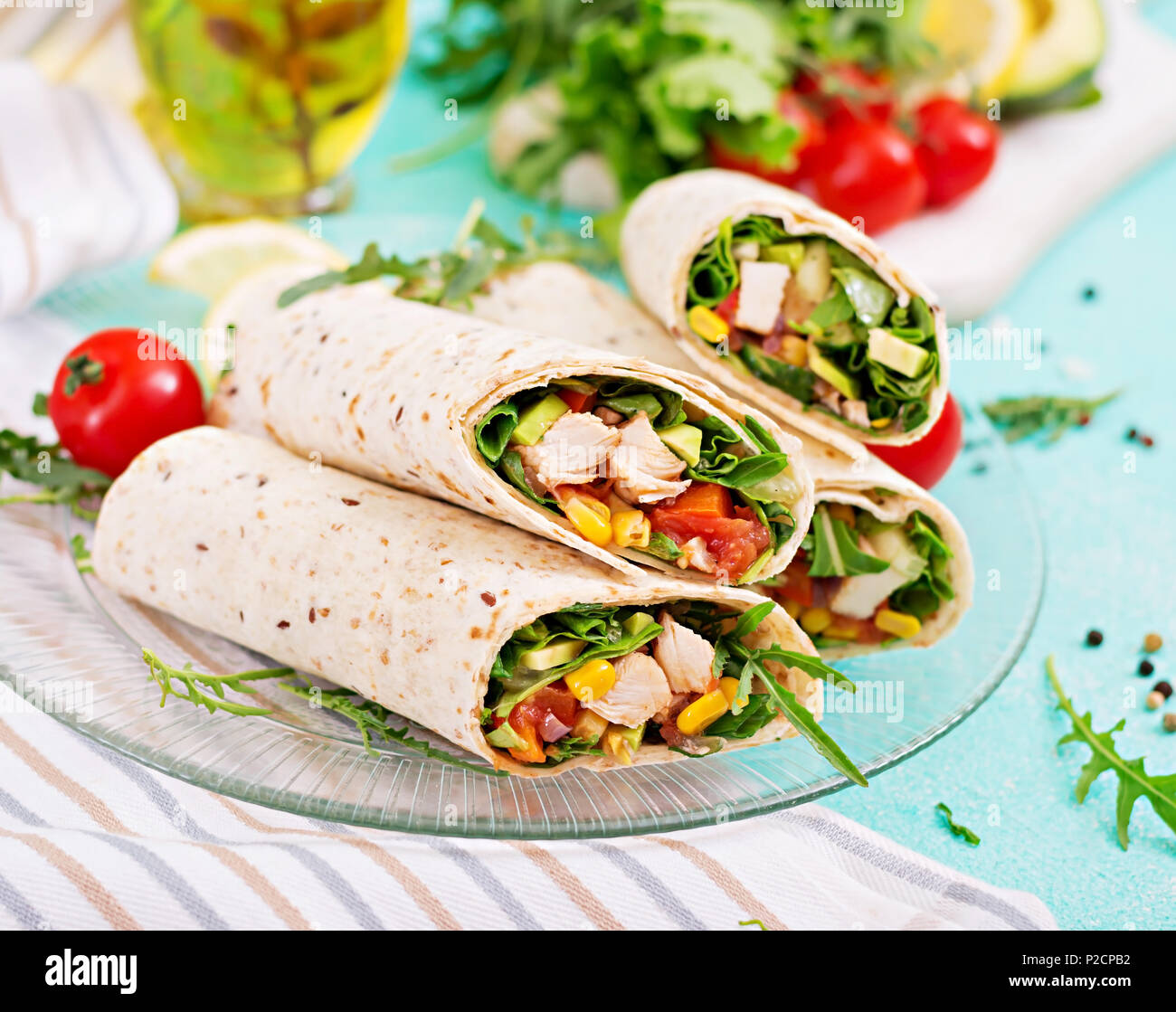 Burritos wraps with chicken and vegetables on light background. Chicken burrito, mexican food ...