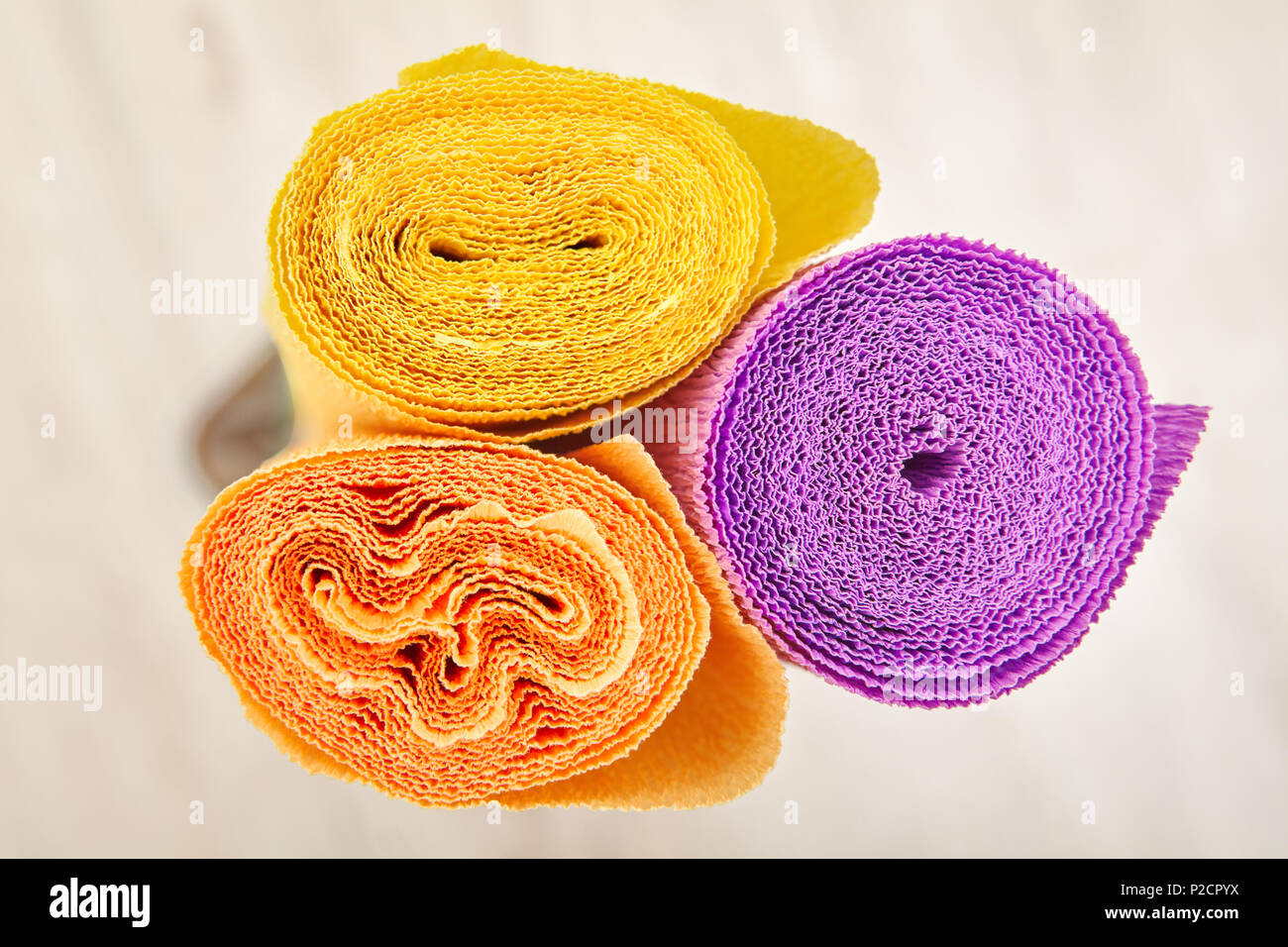 Top view of three rolls of colored corrugated paper for creativity and ...