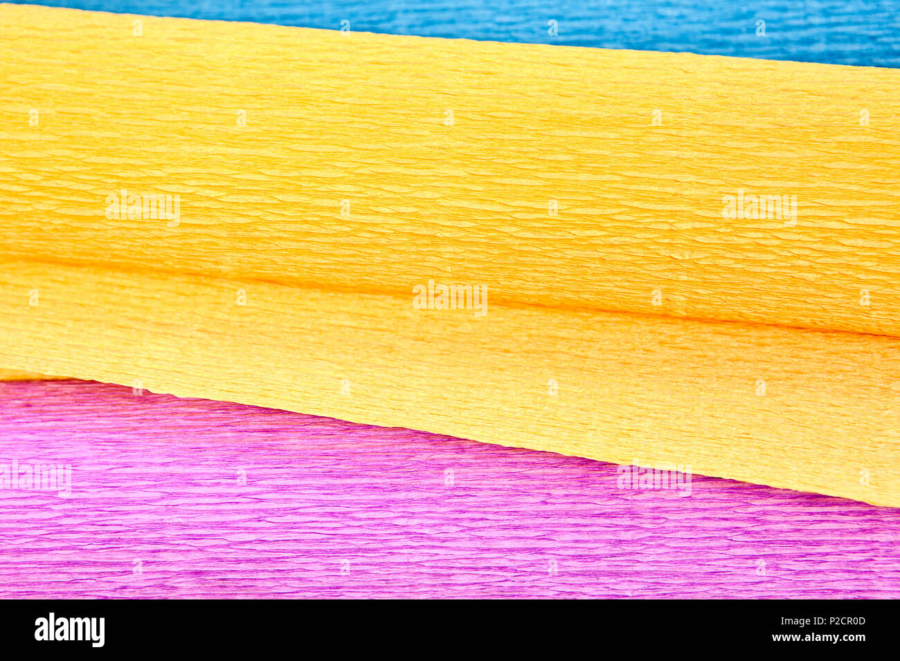 Rolls of crepe paper yellow, purple and blue colors, close-up Stock ...