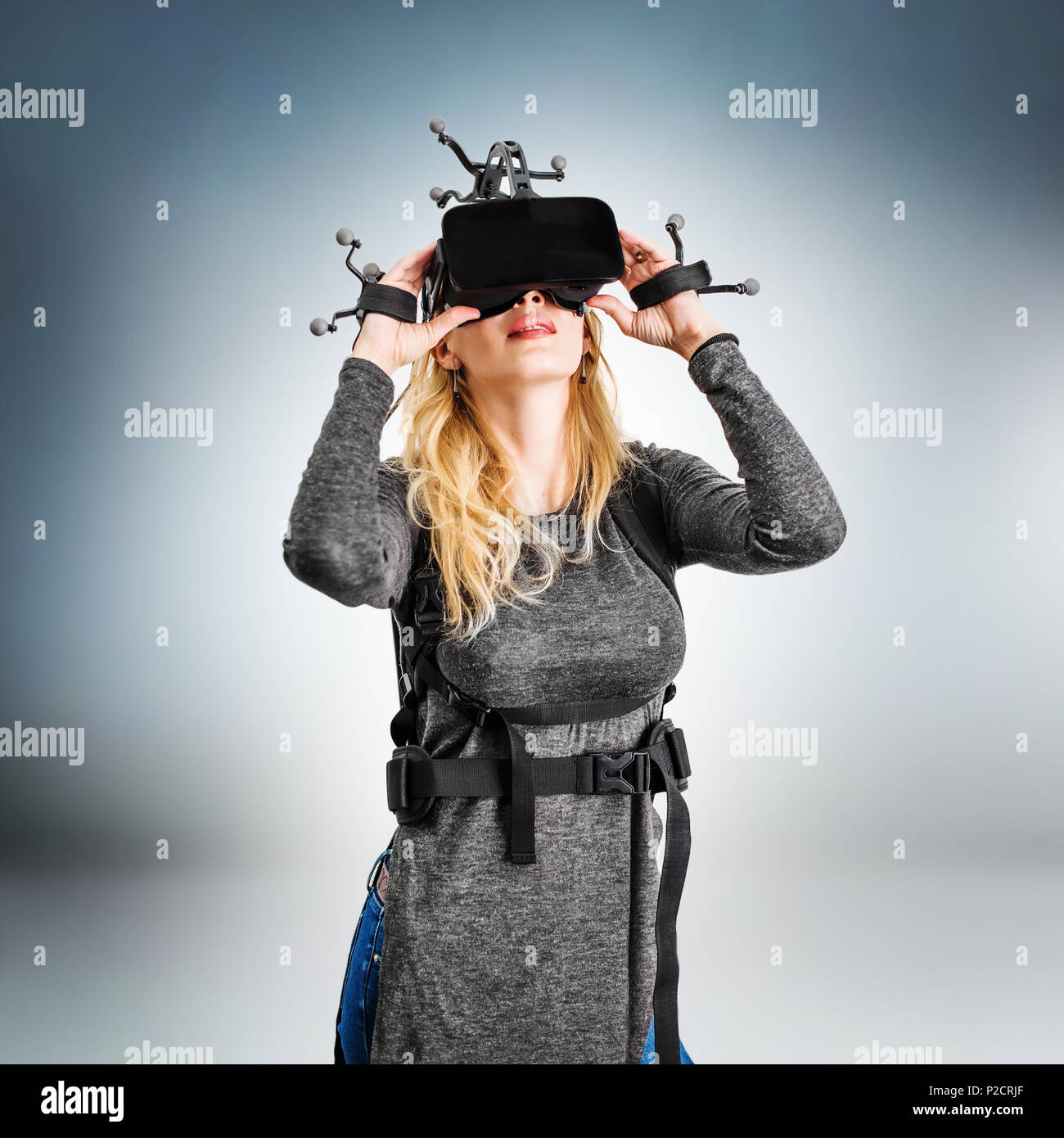 Virtual Reality vr shot. Young woman in studio on grey background Stock ...