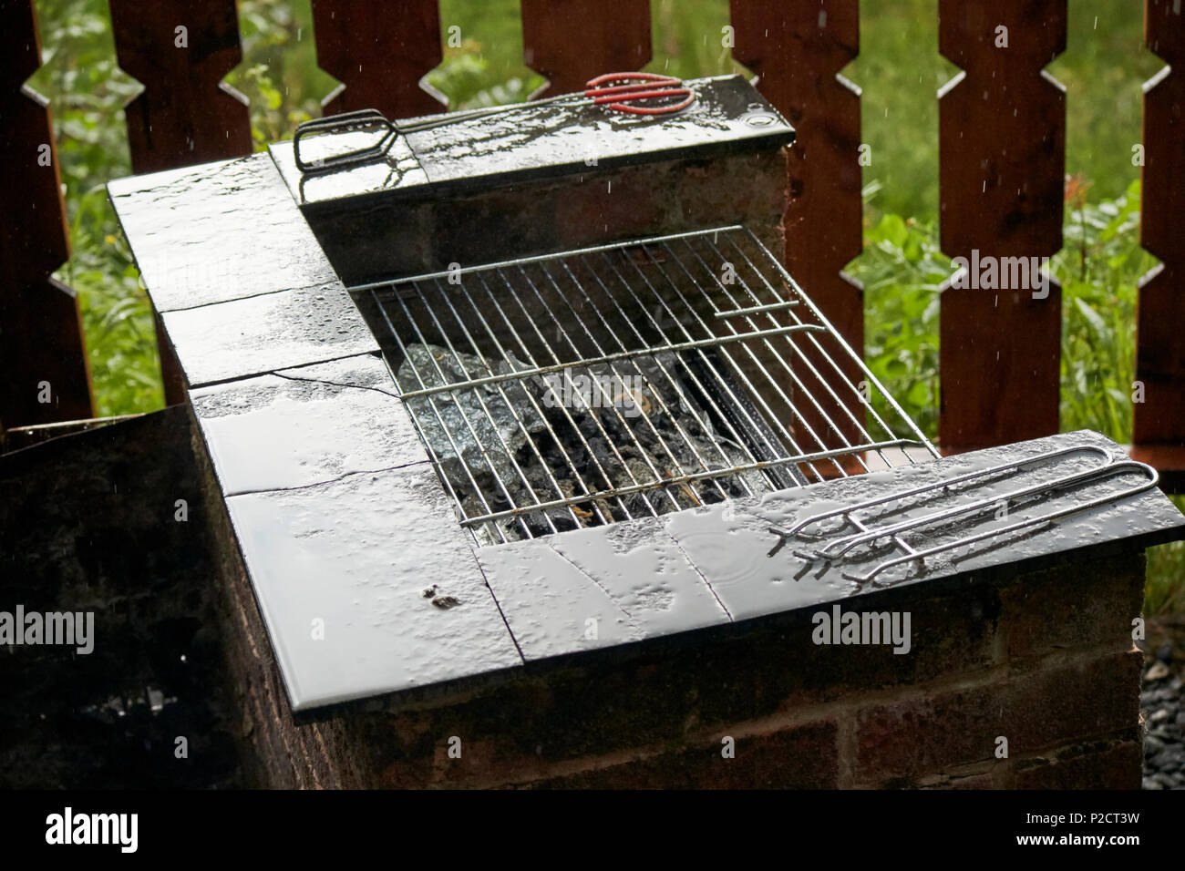 rain falling on brick barbecue in the uk on a typical rainy british ...