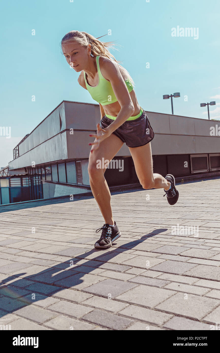 Pretty sporty woman jogging at city Stock Photo - Alamy