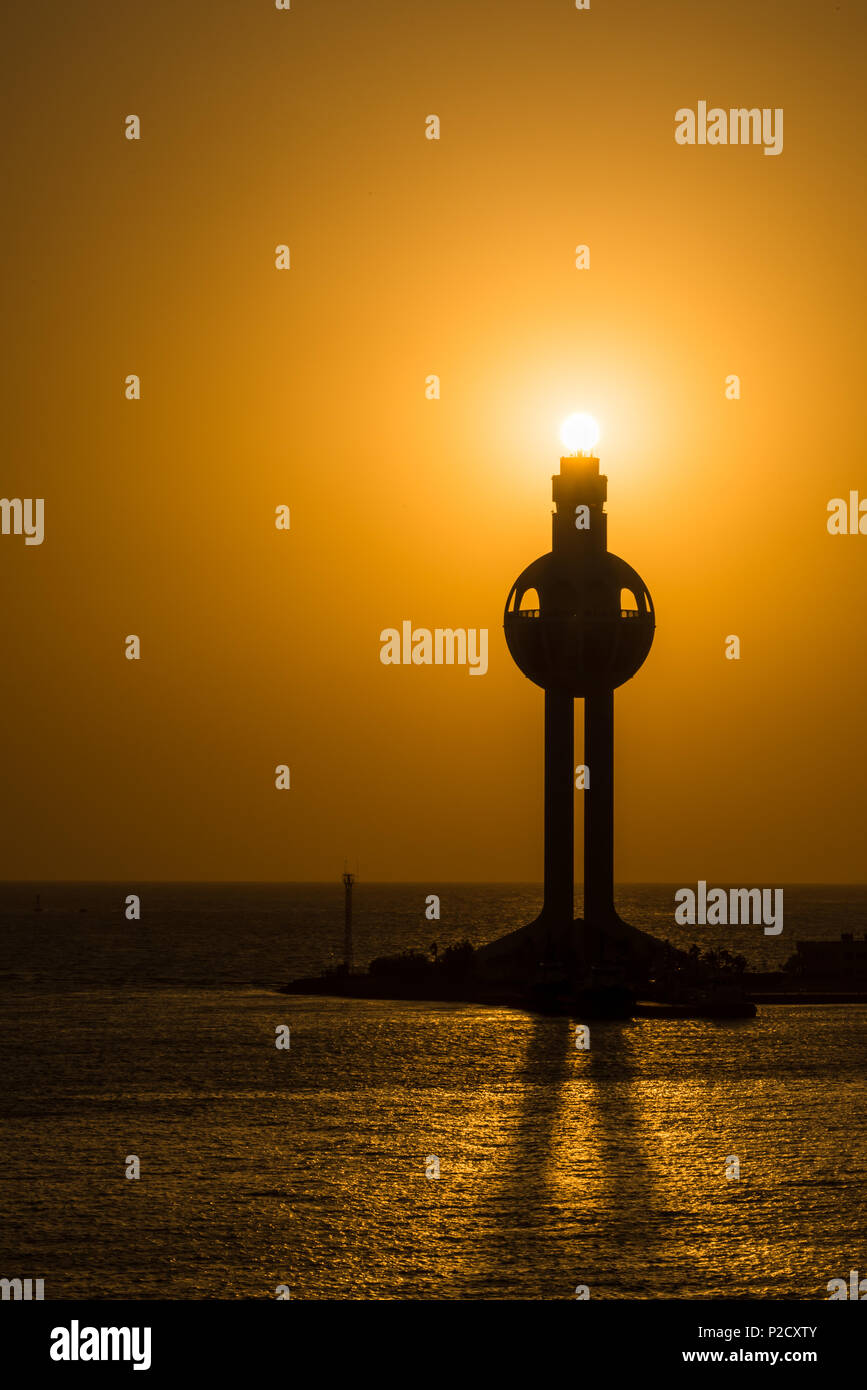 The sun sets behind the tallest lighthouse in the world, located in ...